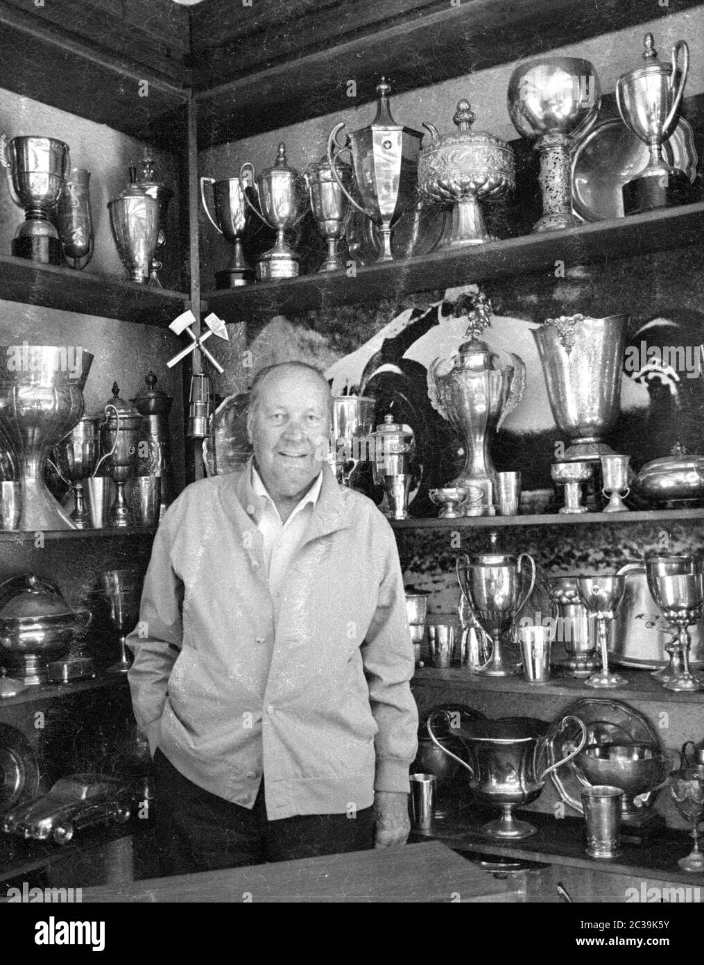 The racing driver Hans Stuck poses for a photo in front of his trophies ...