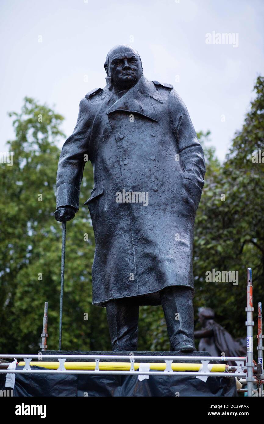 Workmen remove the protective box from around the statue of Winston ...
