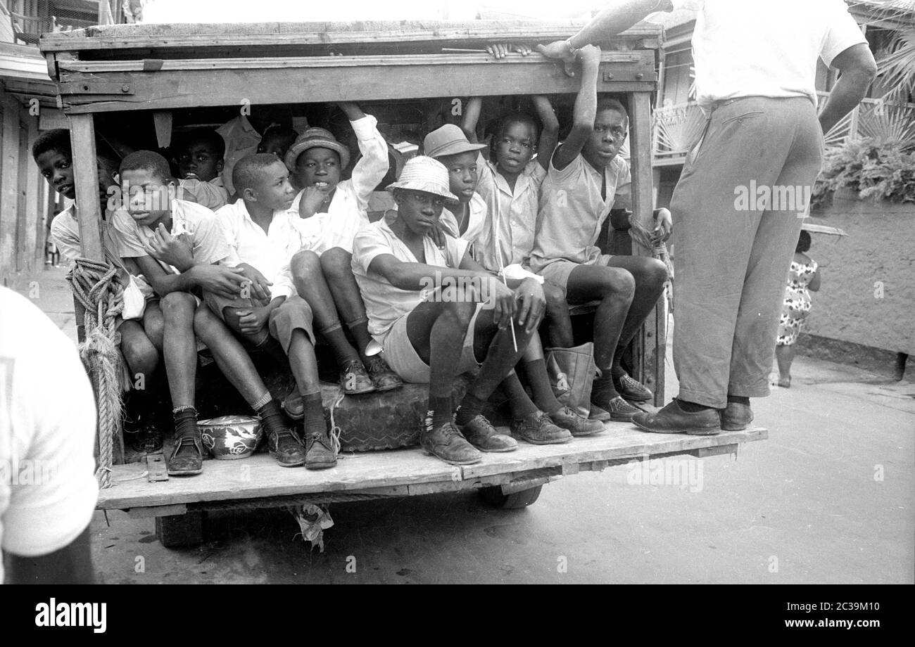 Residents of the Caribbean island of Antigua sit crowded on a van Stock ...