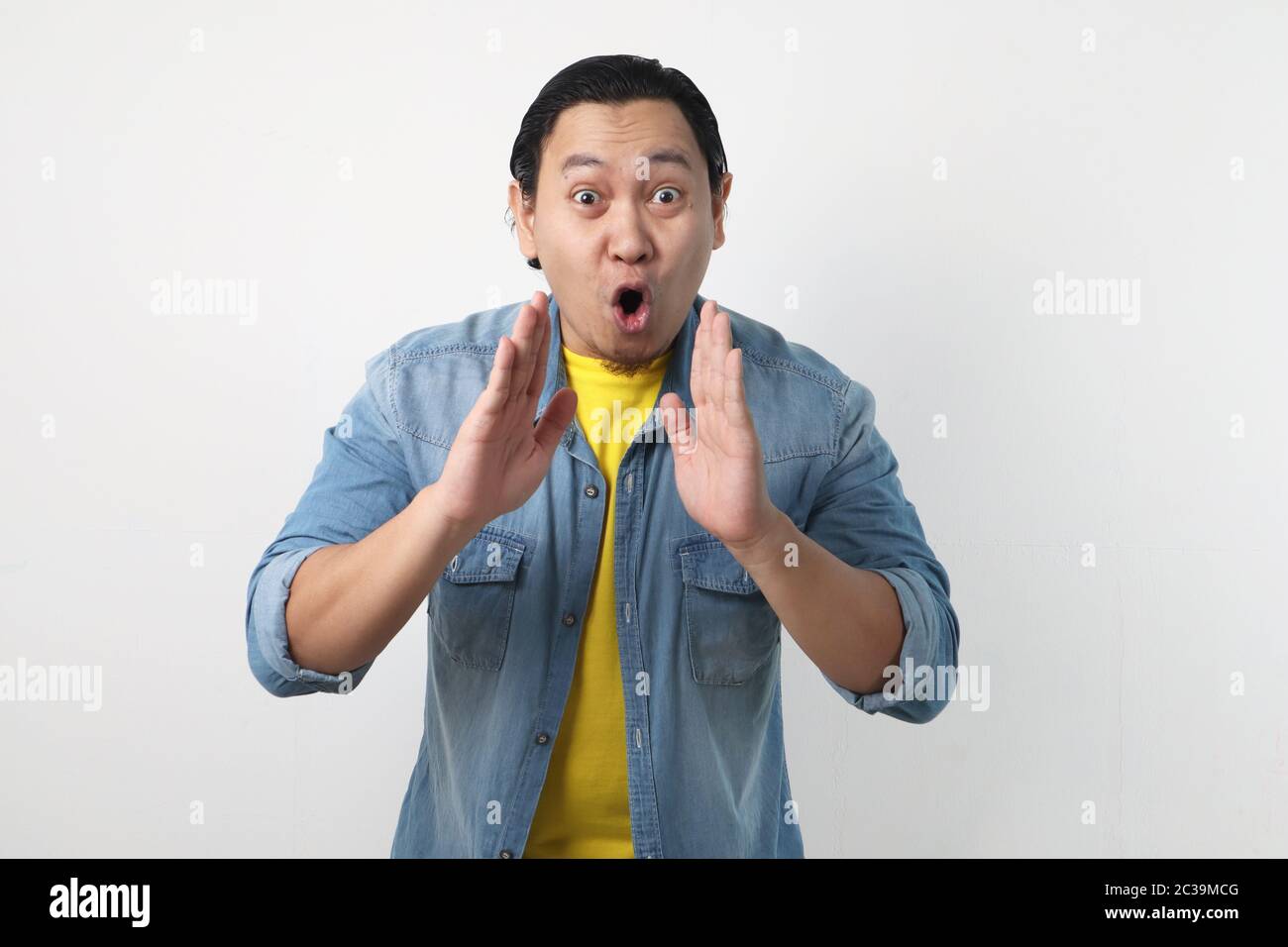Portrait of funny young Asian man shouting and yelling Stock Photo - Alamy