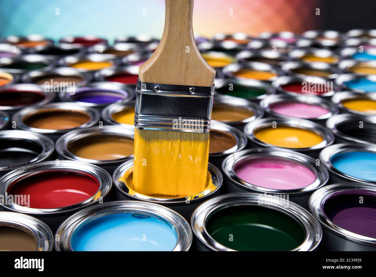 Tin metal cans with color paint and paintbrush Stock Photo - Alamy