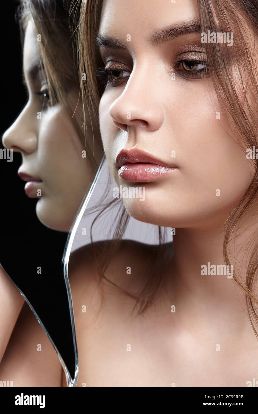 Female With Mirror Shard In Hand Posing On Gray Background Face Reflection In Mirror Splinter