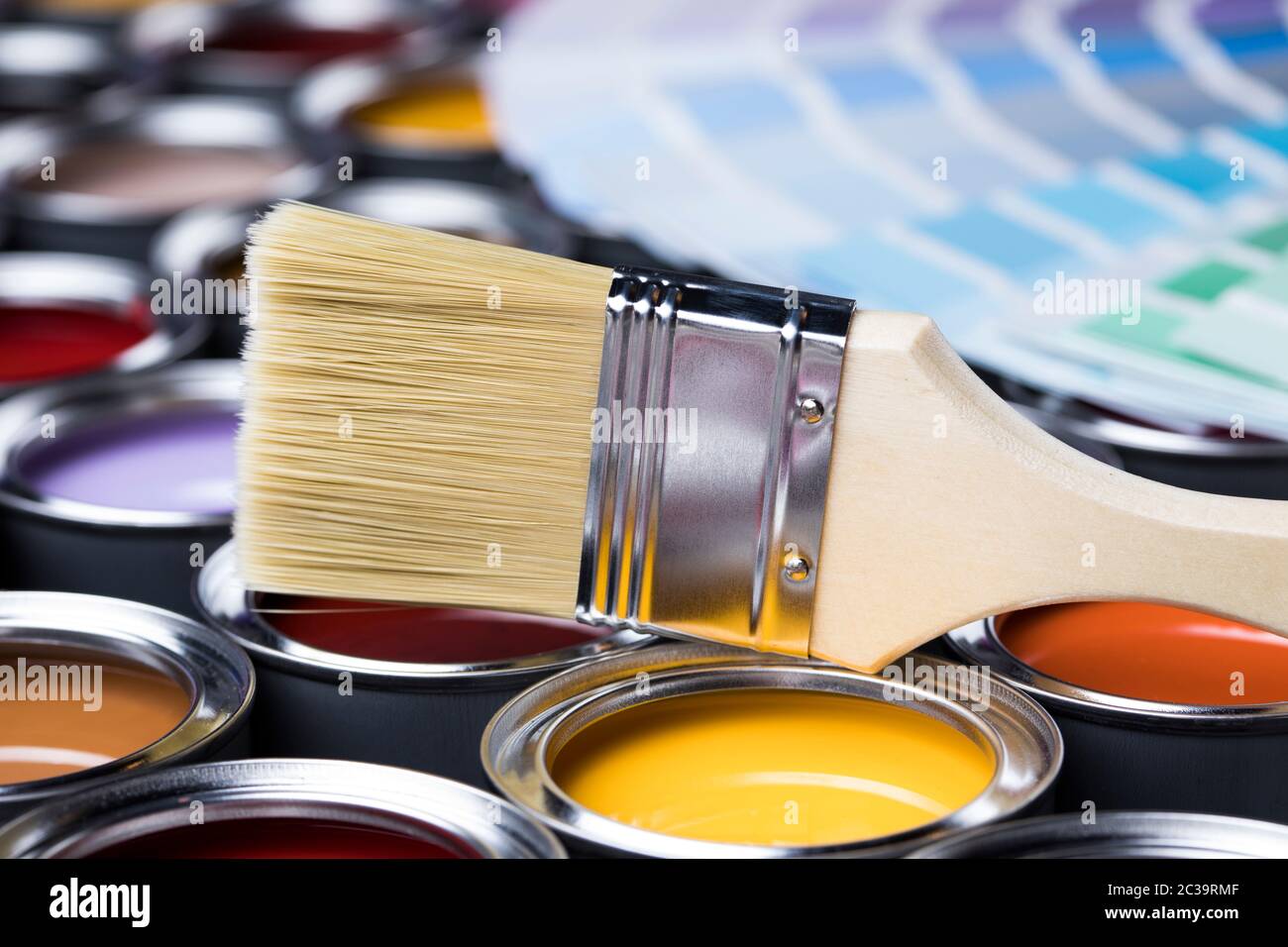 Tin metal cans with color paint and paintbrush Stock Photo - Alamy