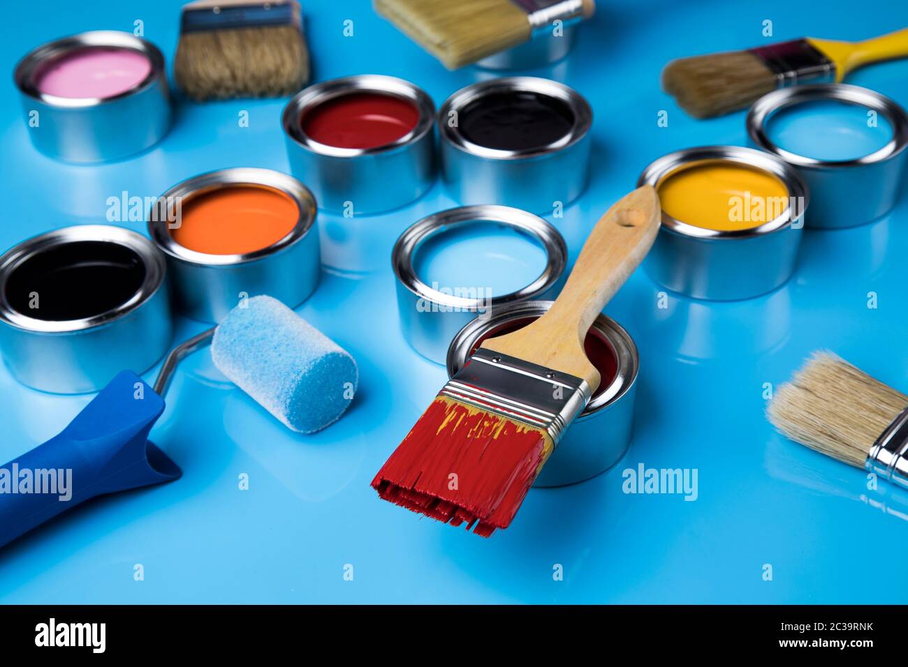 Tin metal cans with color paint and paintbrush Stock Photo - Alamy
