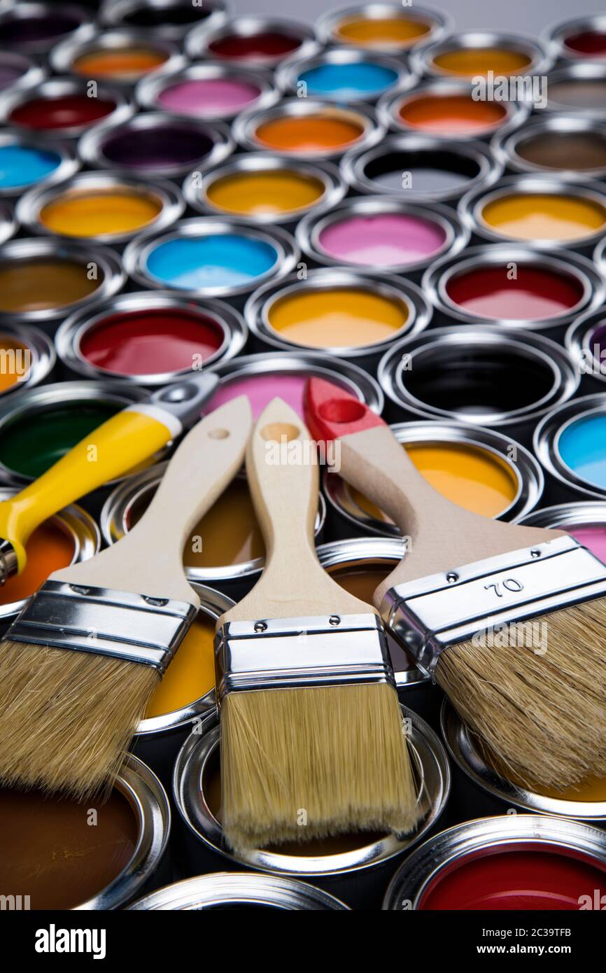 Metal tin cans with color paint and paintbrush Stock Photo - Alamy