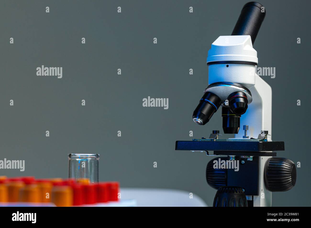 Laboratory microscope with colorful test tubes close up Stock Photo - Alamy