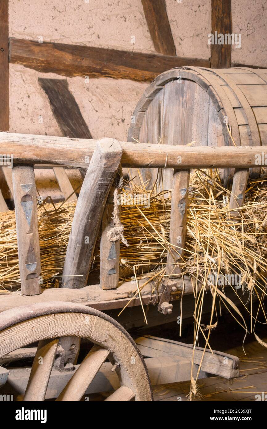 Old hay wagon with a slurry tanker on a layer of straw Stock Photo - Alamy
