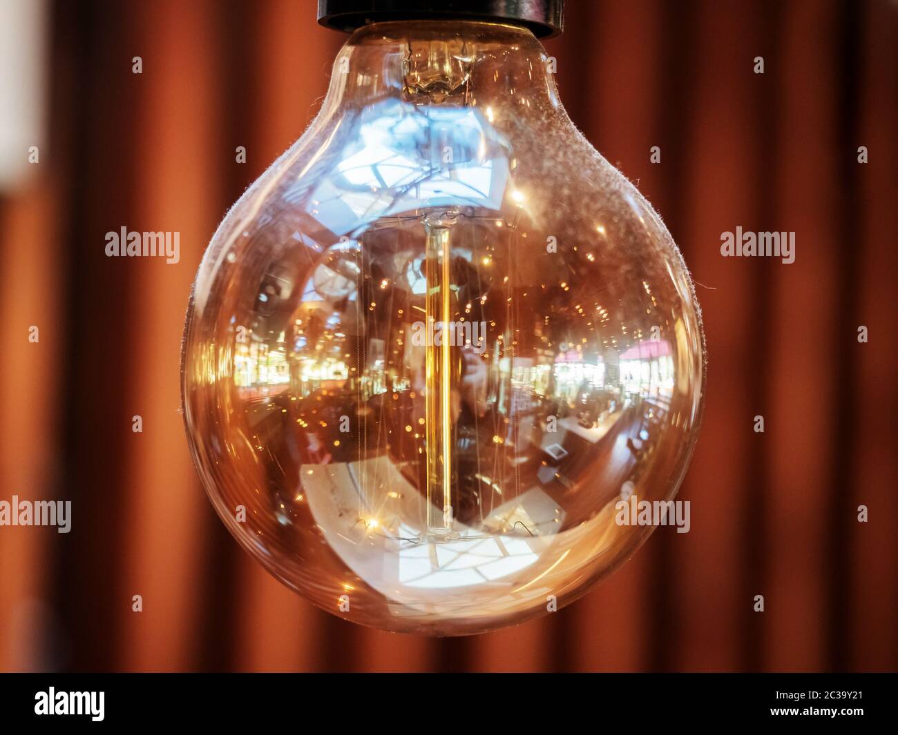 Close-up photo of a transparent light bulb with an interior reflected ...
