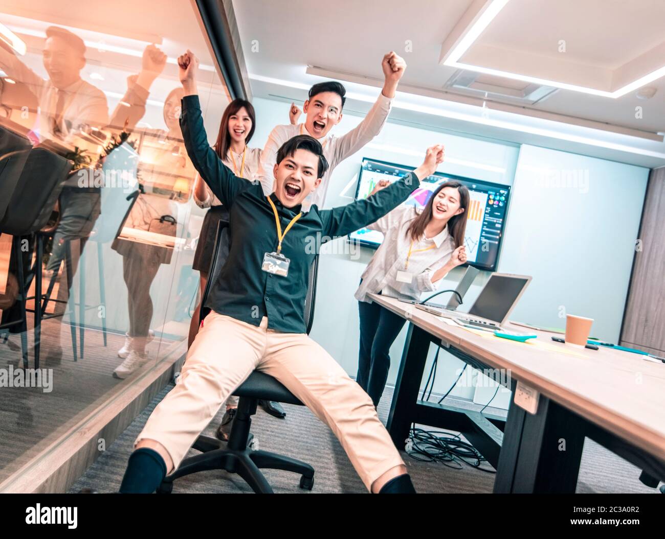 business people having fun riding on chairs in office Stock Photo - Alamy