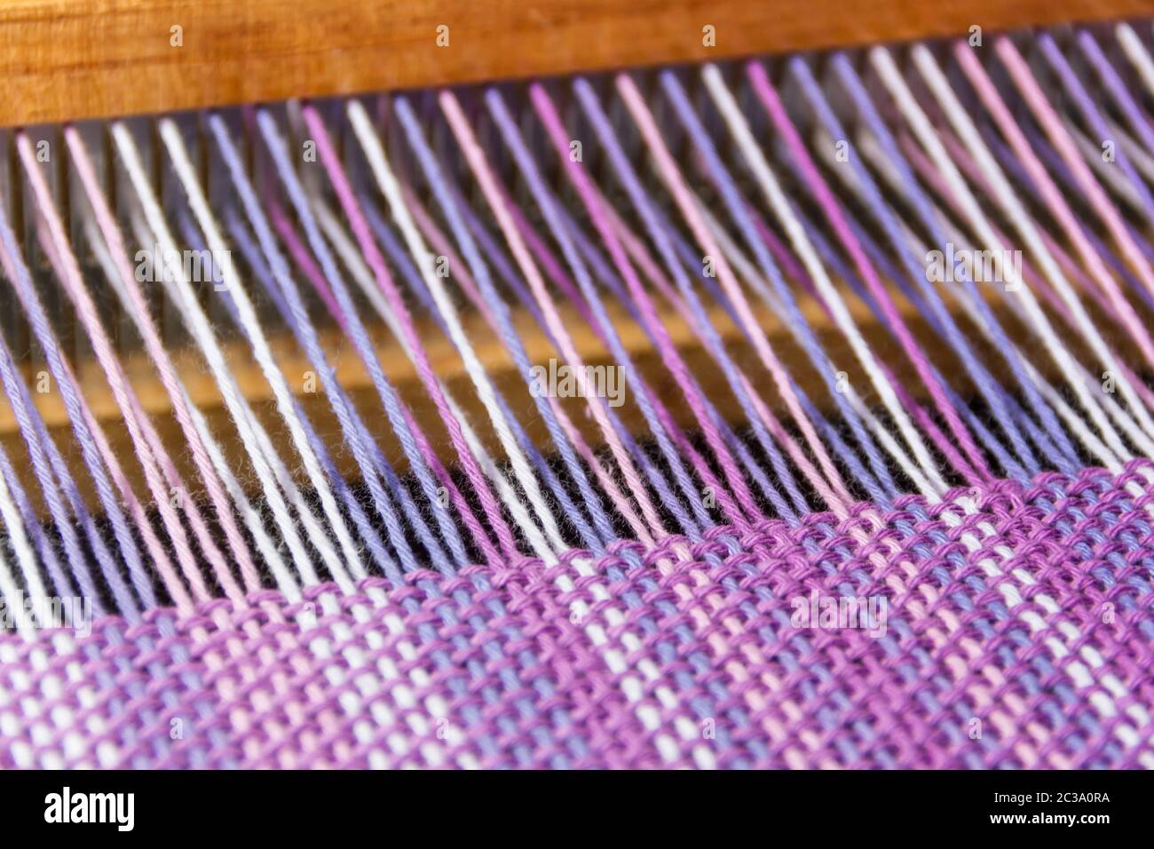 detail of fabric in comb loom with ultraviolet and lilac colors Stock ...