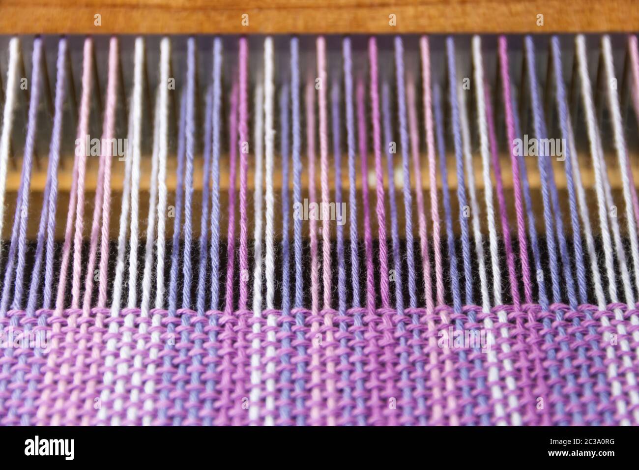 detail of fabric in comb loom with ultraviolet and lilac colors Stock ...