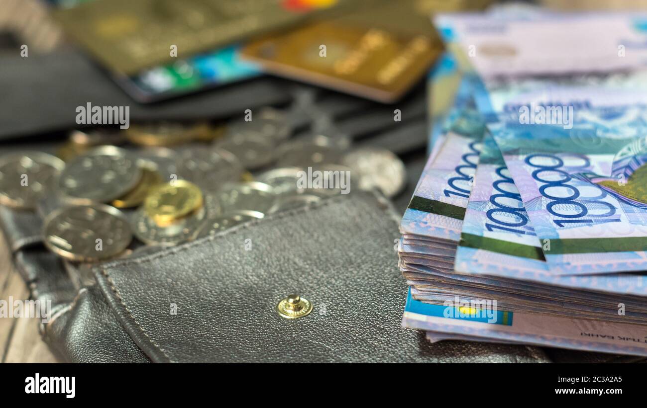 Paper banknotes tenge KZT with credit cards on a back background. Tenge ...
