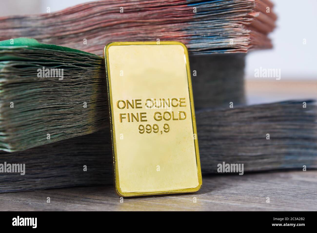 Paper banknotes tenge KZT with gold ingot. Tenge is the national ...