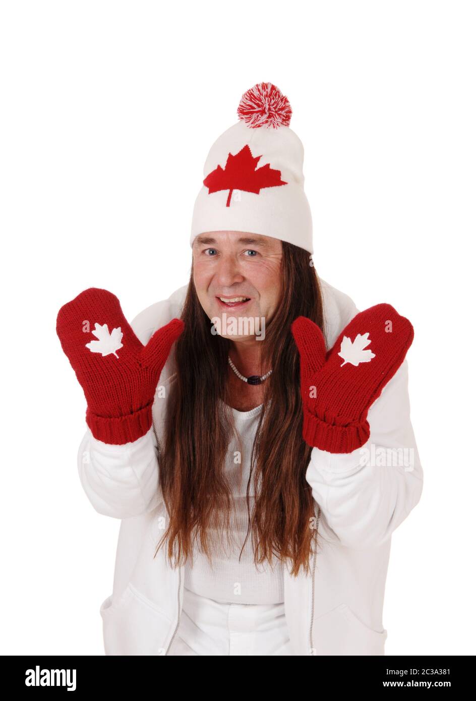 A happy indigenous man dressed in white with a hat and mittens with the ...