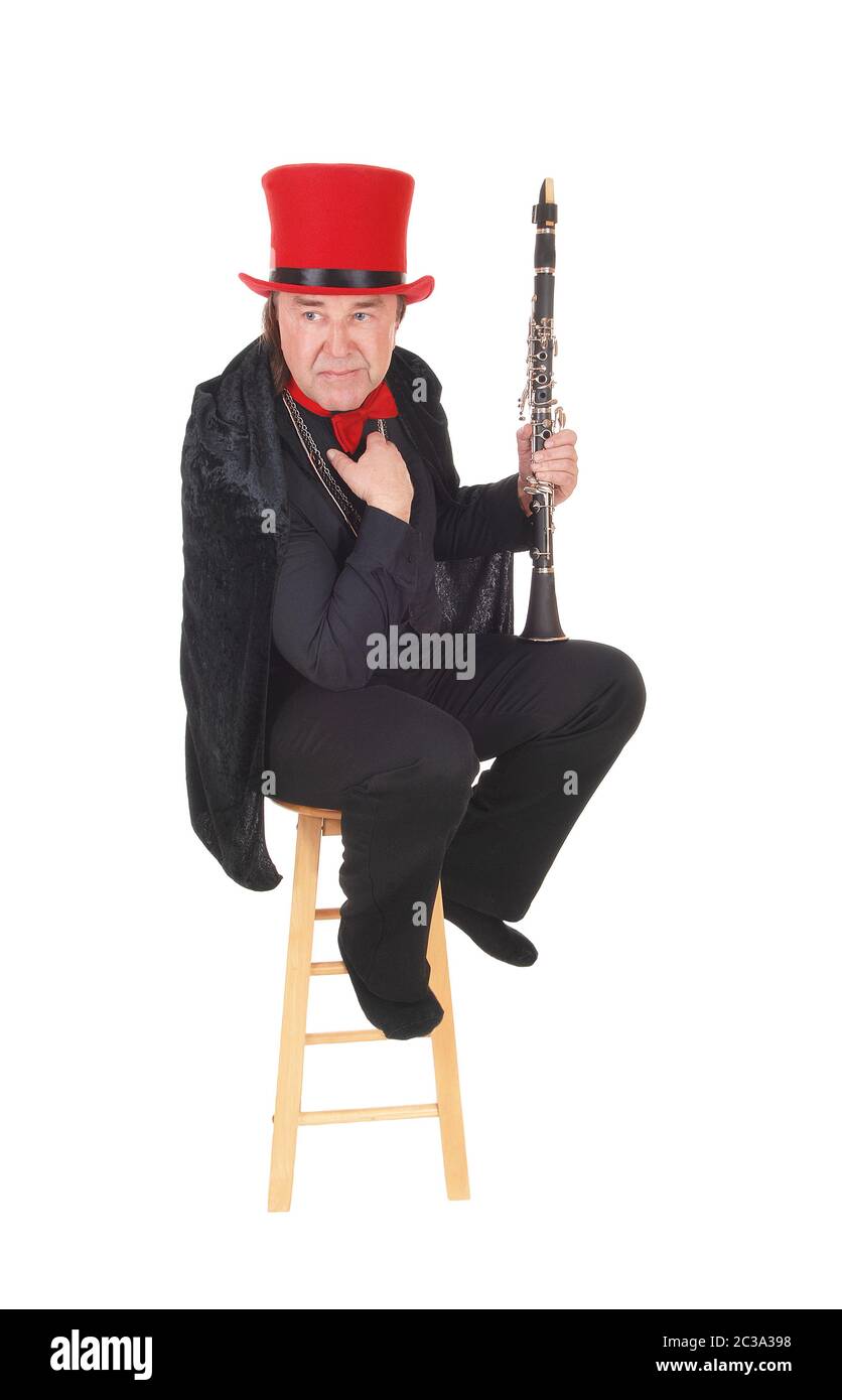 A middle age indigenous man playing his clarinet in a black outfit and ...