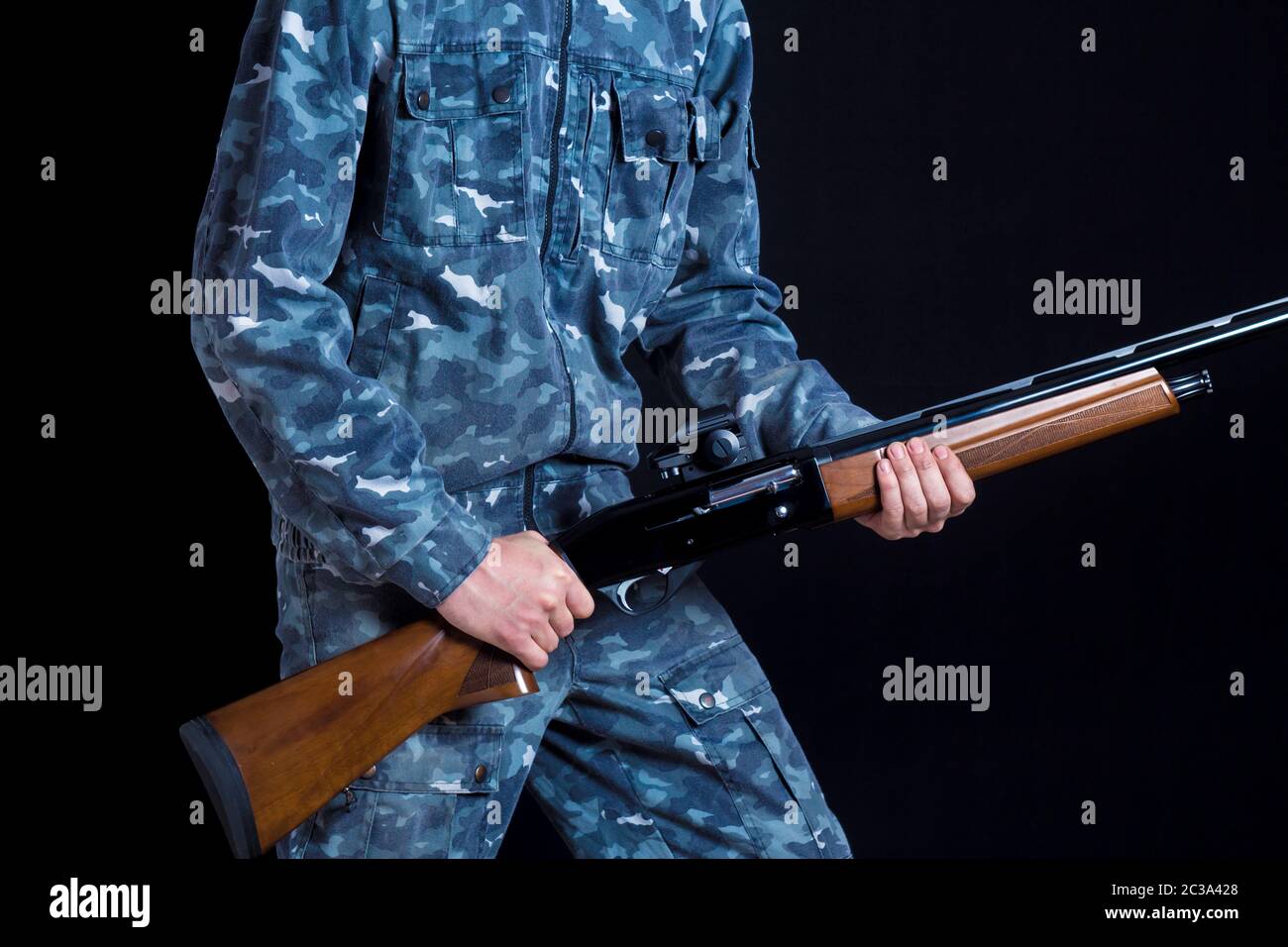 A soldier in military uniform with a shotgun. War games. Preparation ...