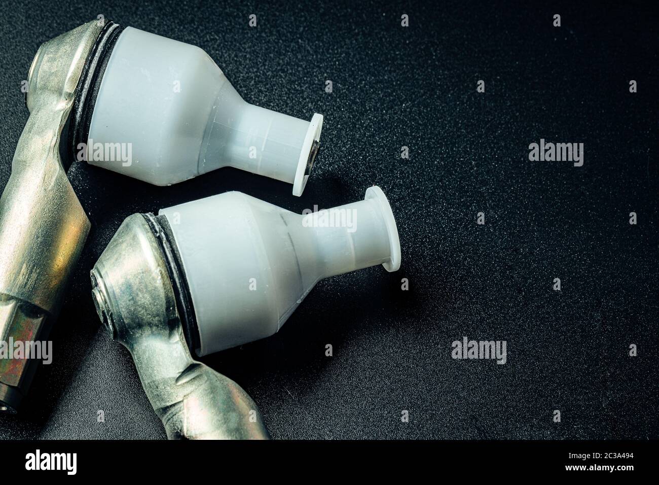 Car steering rod tip on black background Stock Photo - Alamy
