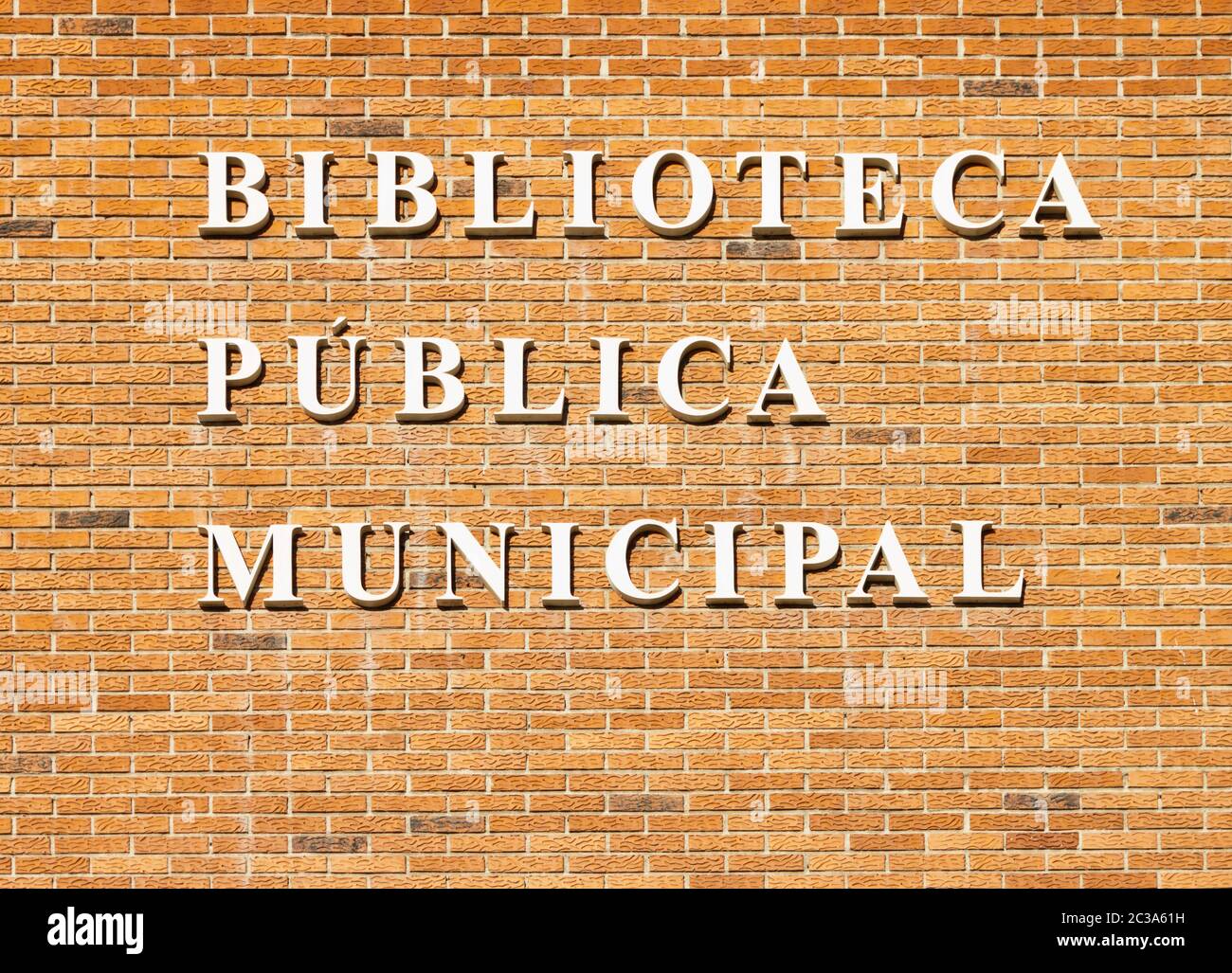 Biblioteca publica municipal sign on masonry wall background. City ...