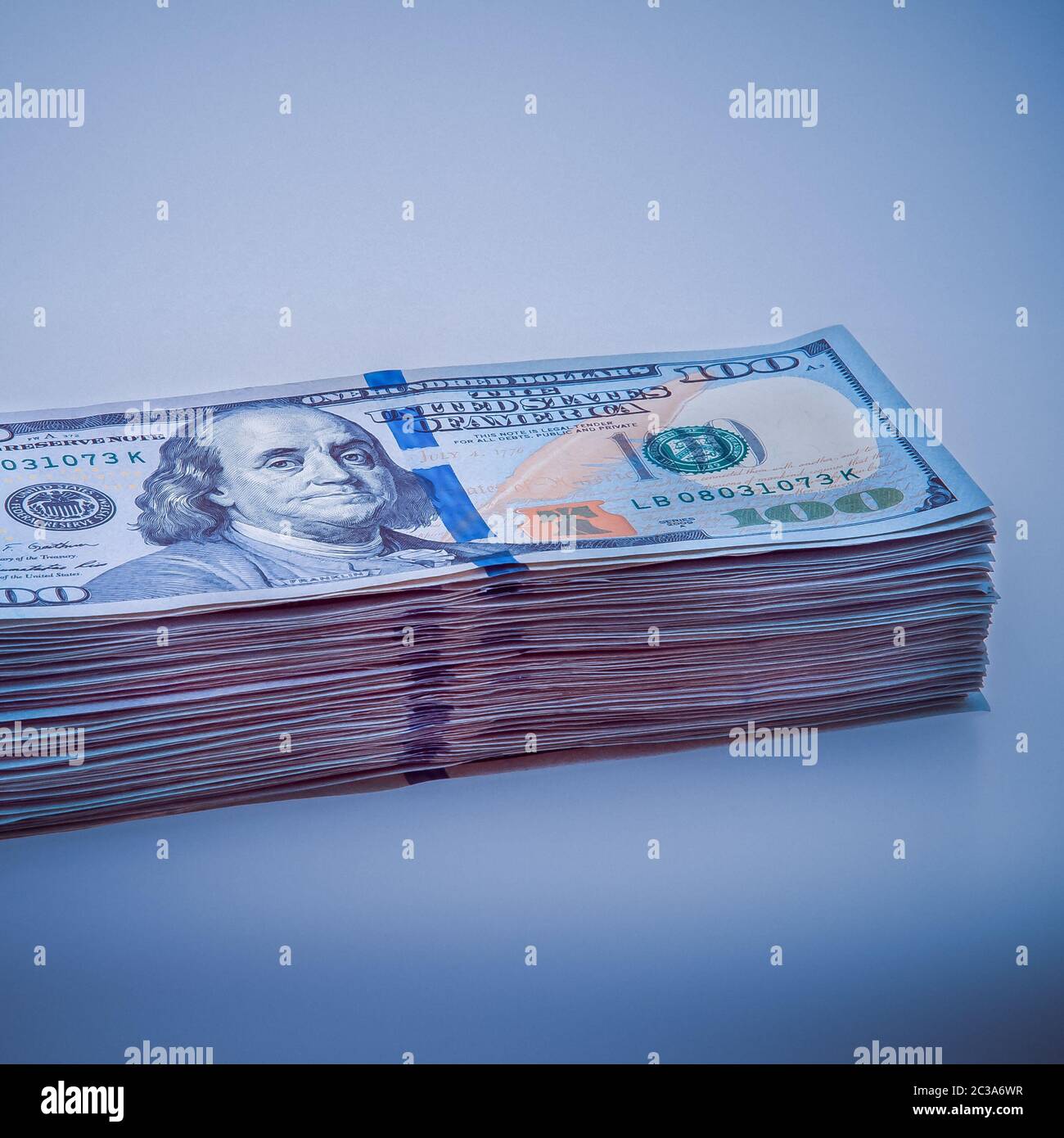 A big stack of hundred-dollar bills. Blue design. Vignetting Stock ...