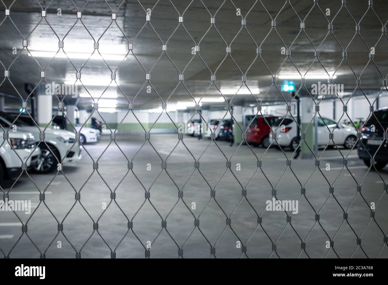 Gated underground parking. Cars parked in a garage with no people. Many ...