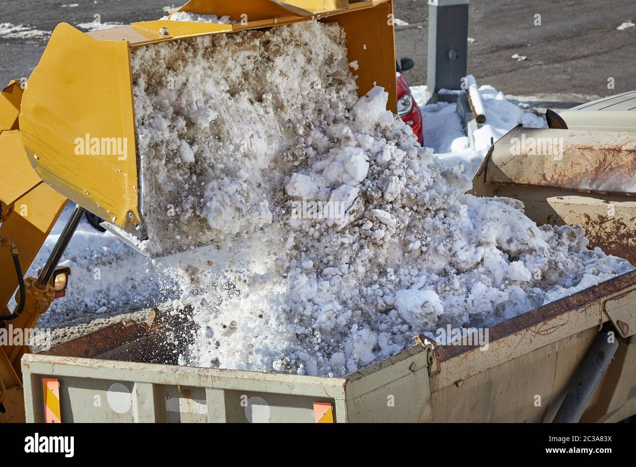 Removing snow from the road, loading on a dump truck Stock Photo - Alamy