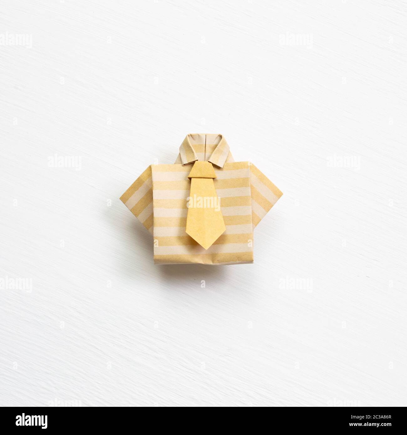 Stripe pattern paper shirt origami on white background Stock Photo - Alamy