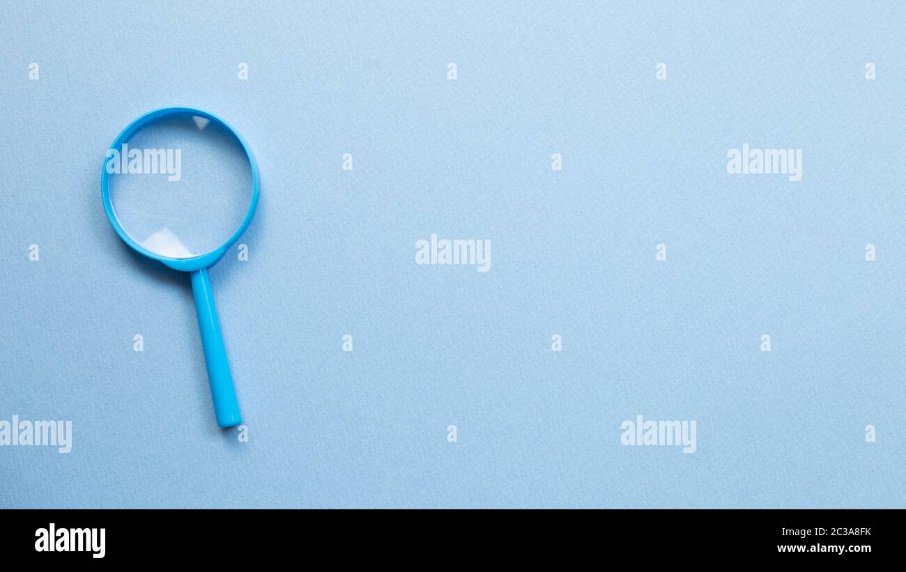 Blue magnifying glass on blue background. top view, copy space Stock ...