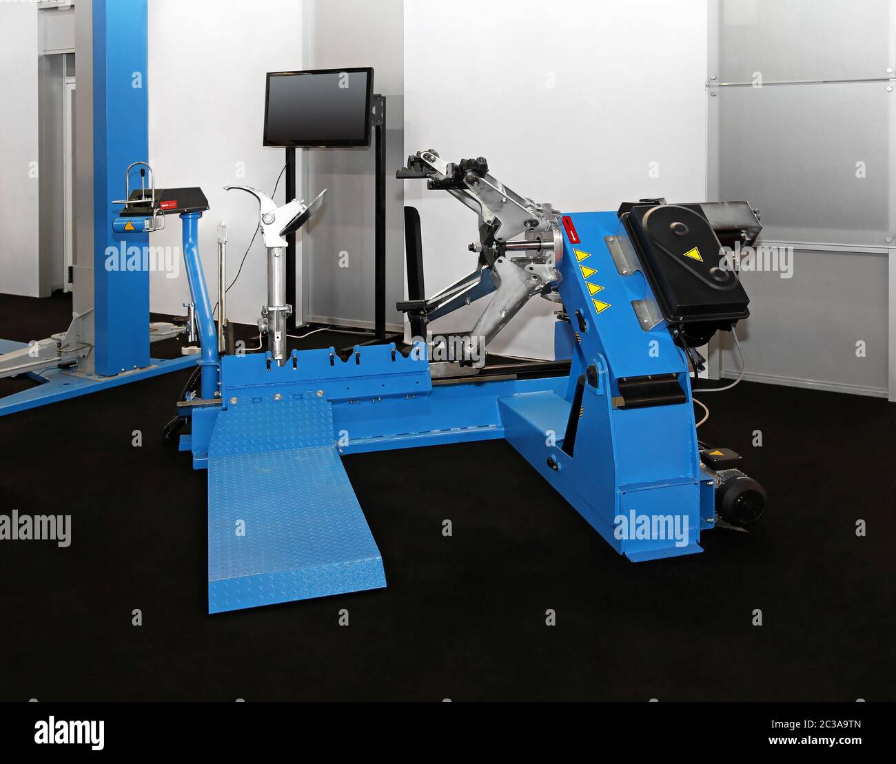 Tyre changer machine in truck service garage Stock Photo - Alamy