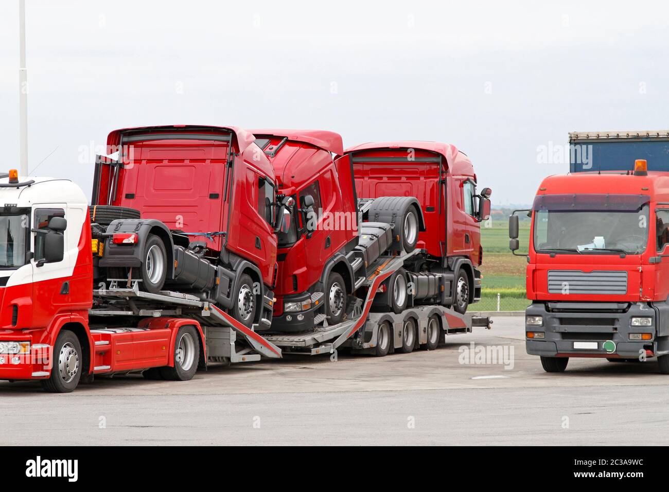 Transporting new red semi trucks at lorry Stock Photo - Alamy