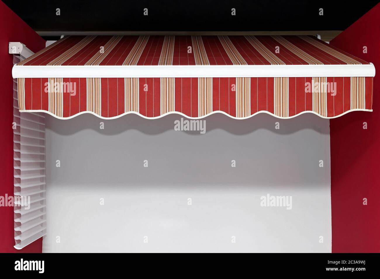Red stripes canopy at retractable sun shade Stock Photo - Alamy
