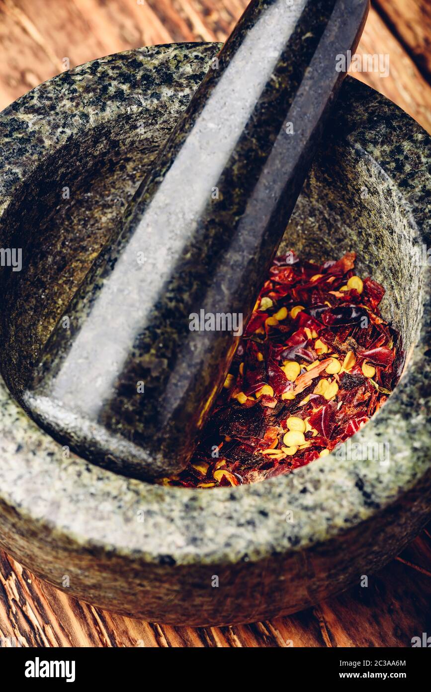 Red chili pepper grinded in mortar. High angle view Stock Photo - Alamy