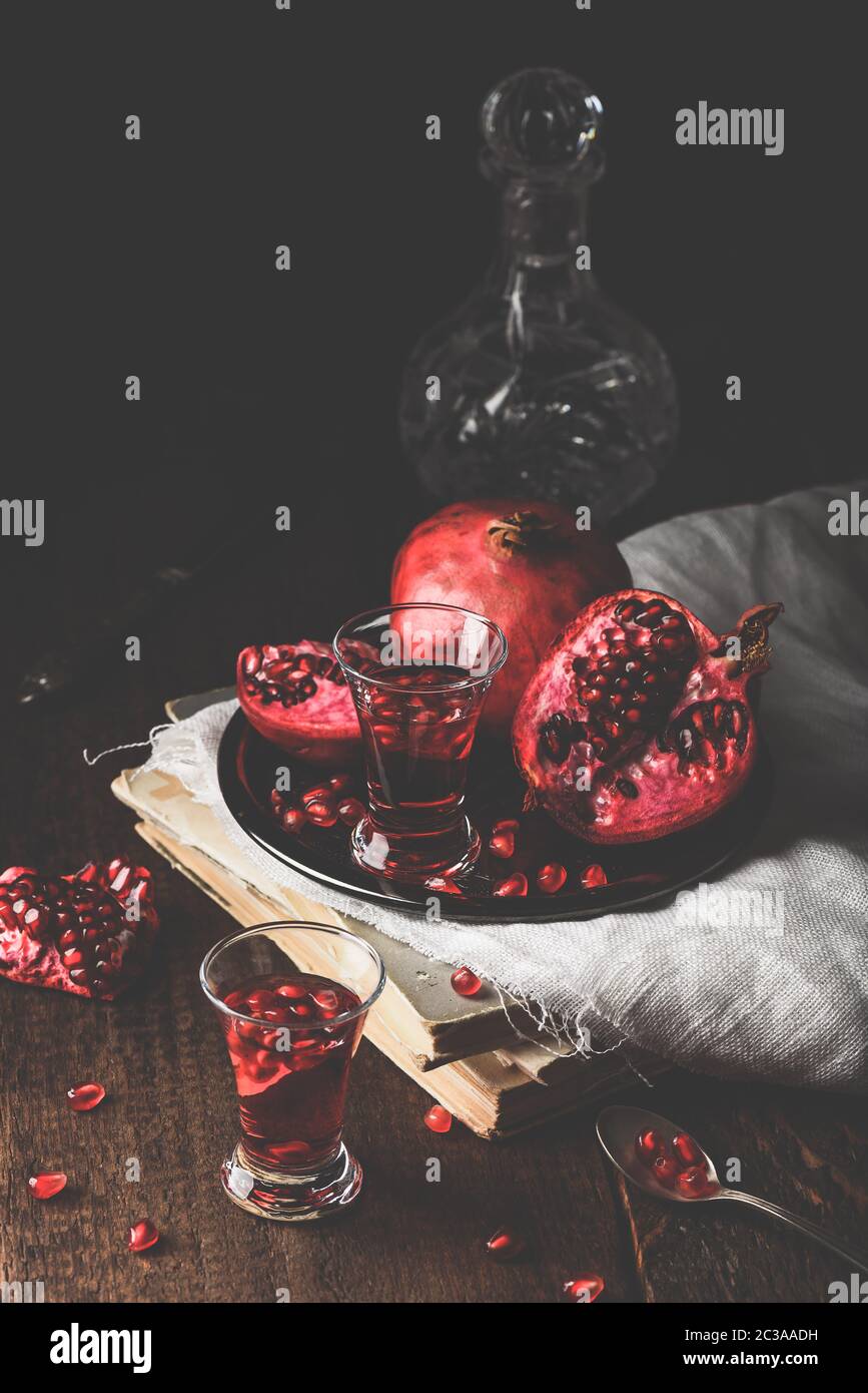 Shots of pomegranate liqueur with fresh fruit Stock Photo - Alamy