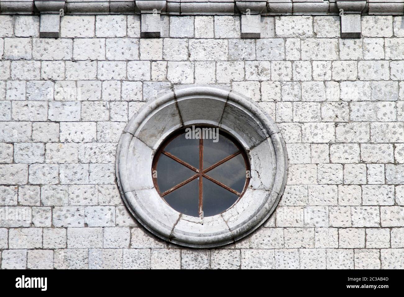 Round window at old stone wall exterior Stock Photo - Alamy