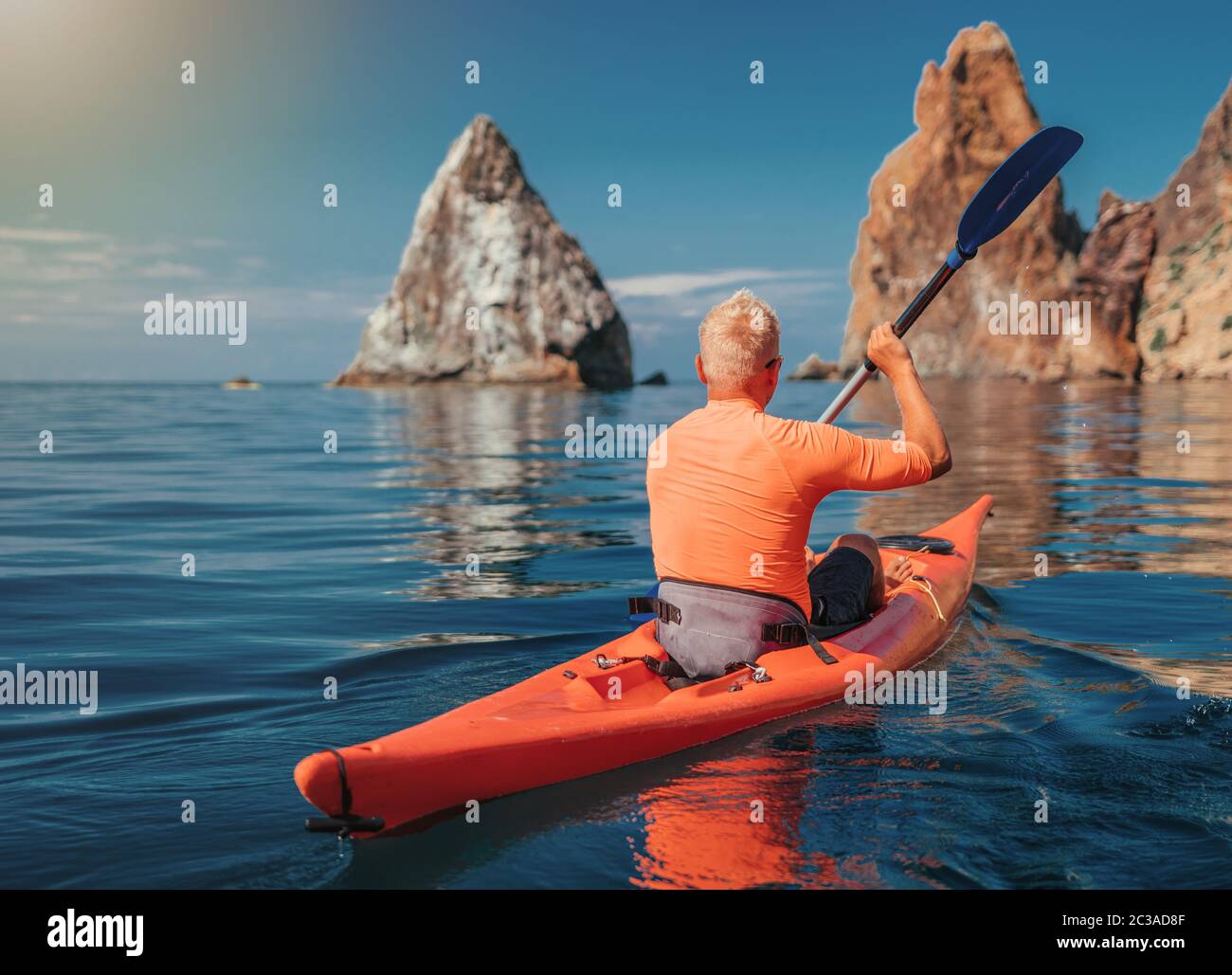 Kayak. Athlete kayaker man enjoys adventure on calm sea with blue water ...