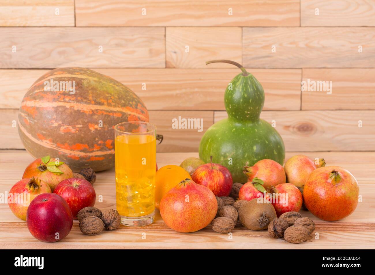 Autumn nature fruits concept. Fall fruits and orange juice, on a wooden ...