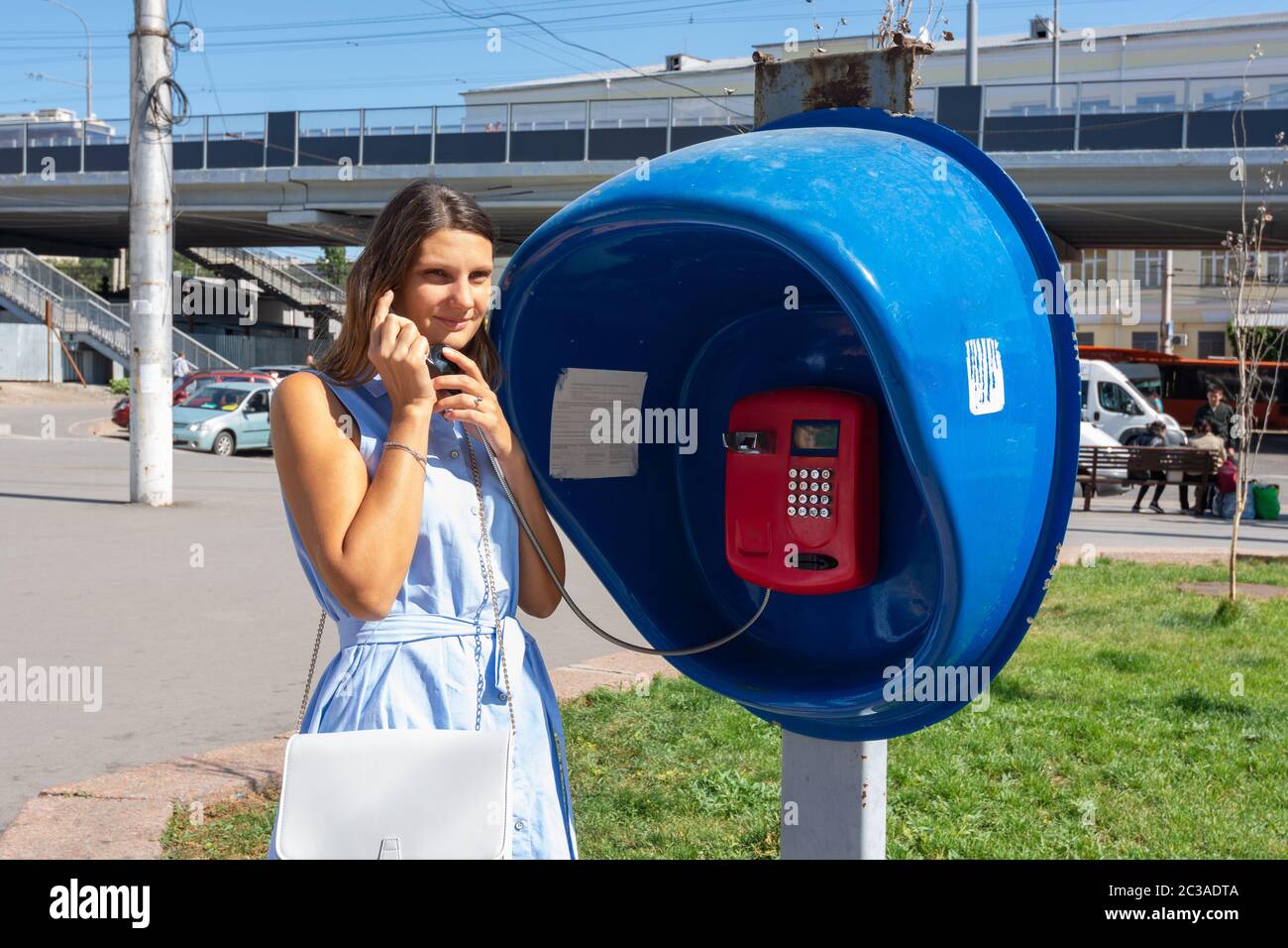 Young pretty girl talking on a payphone on a city street Stock Photo ...