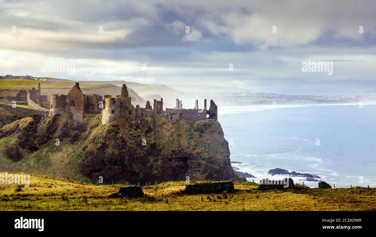 Ruined medieval Dunluce Castle on the cliff in Bushmills, Northern ...