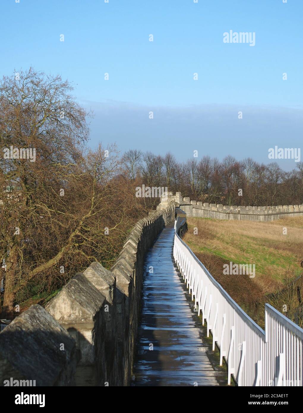 a view along the pedestrian walkway on historic medieval city walls in ...