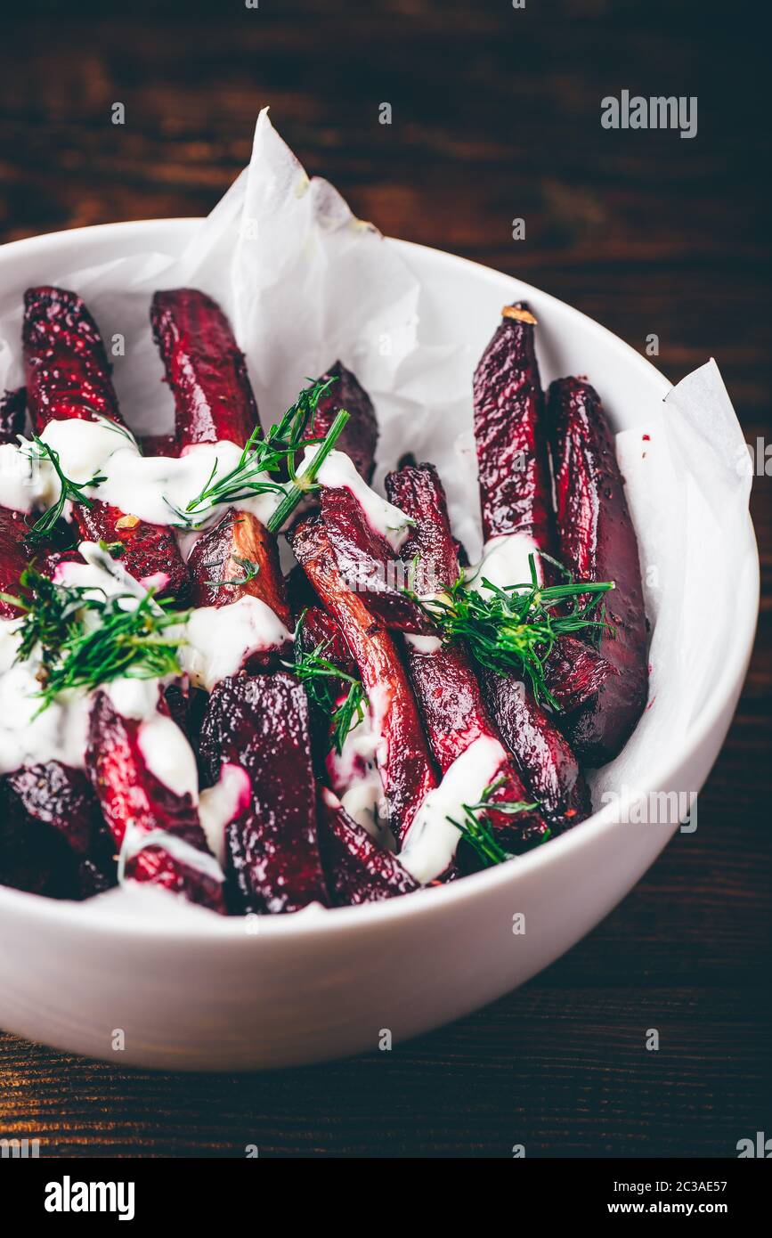 Oven baked beet fries with sour cream and dill dressing Stock Photo - Alamy