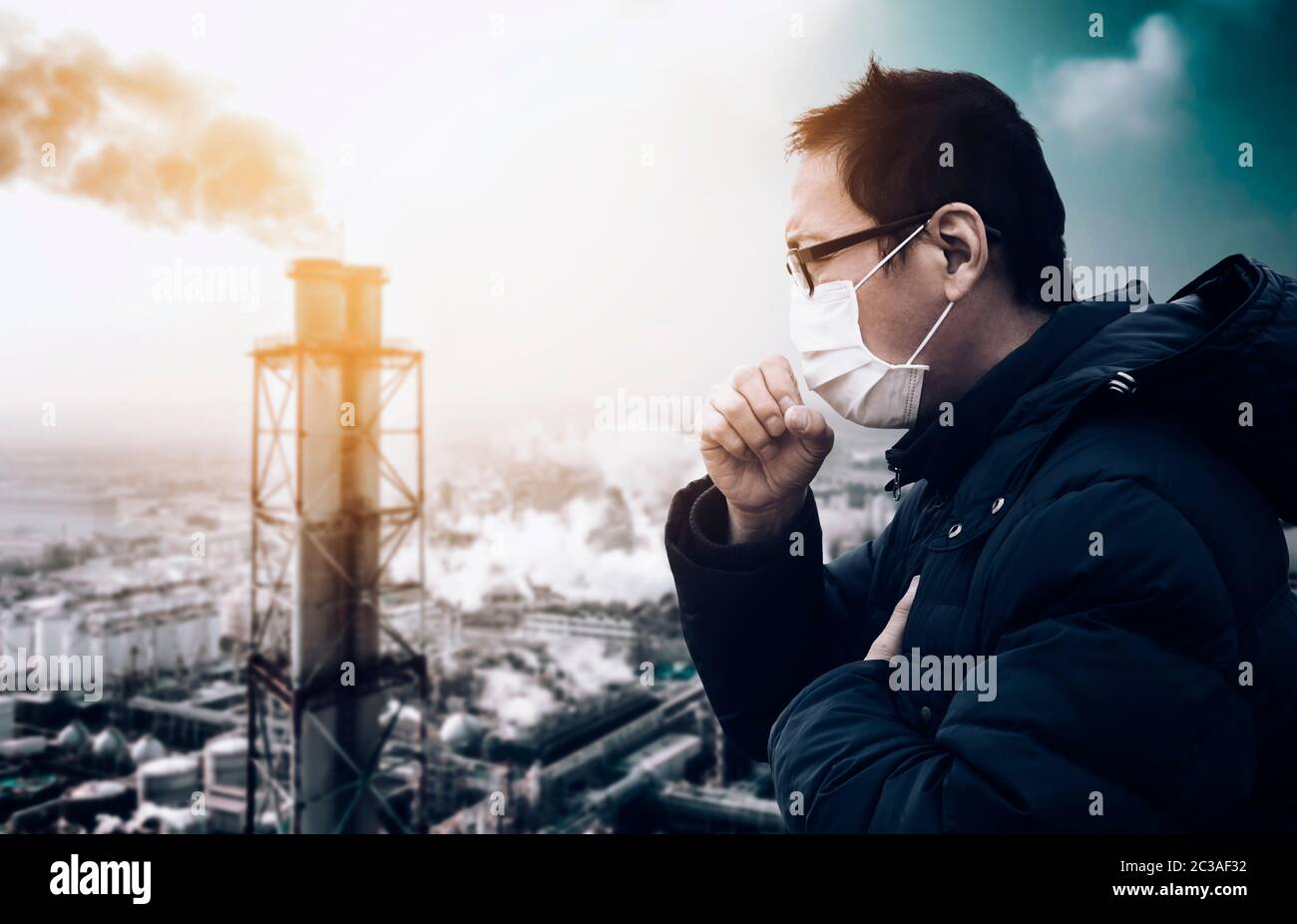 man wearing mask against smog and air pollution factory background ...