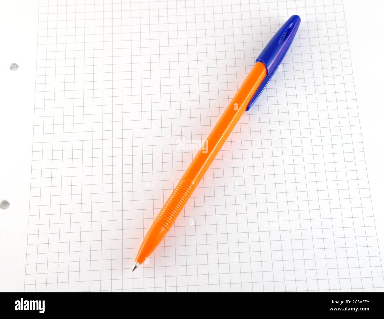 One pen on the checked paper of notepad Stock Photo - Alamy