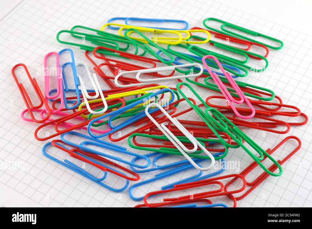 Color clips on checked paper Stock Photo - Alamy