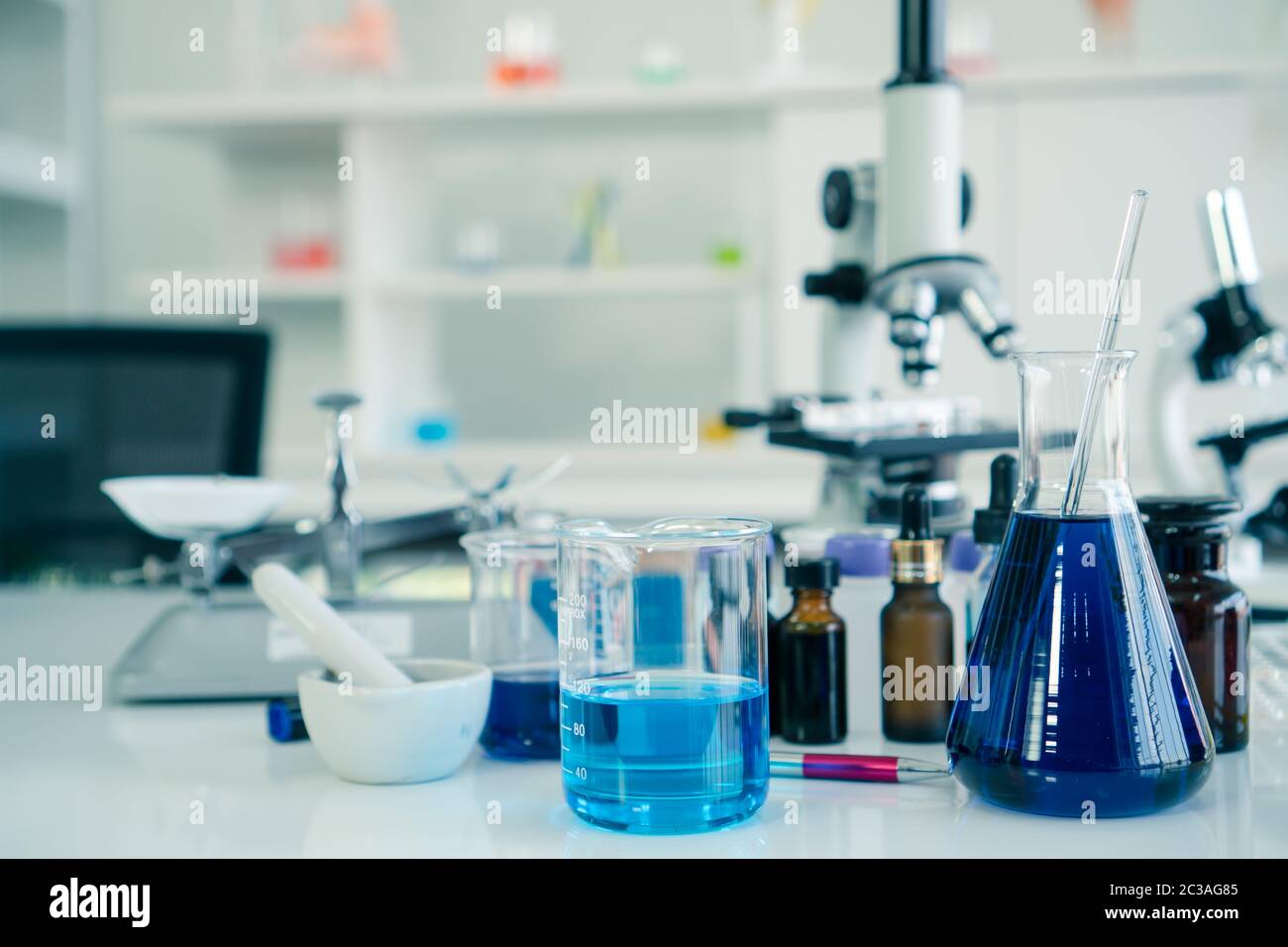 The glass tube filled with blue chemical reagent is a scientific ...