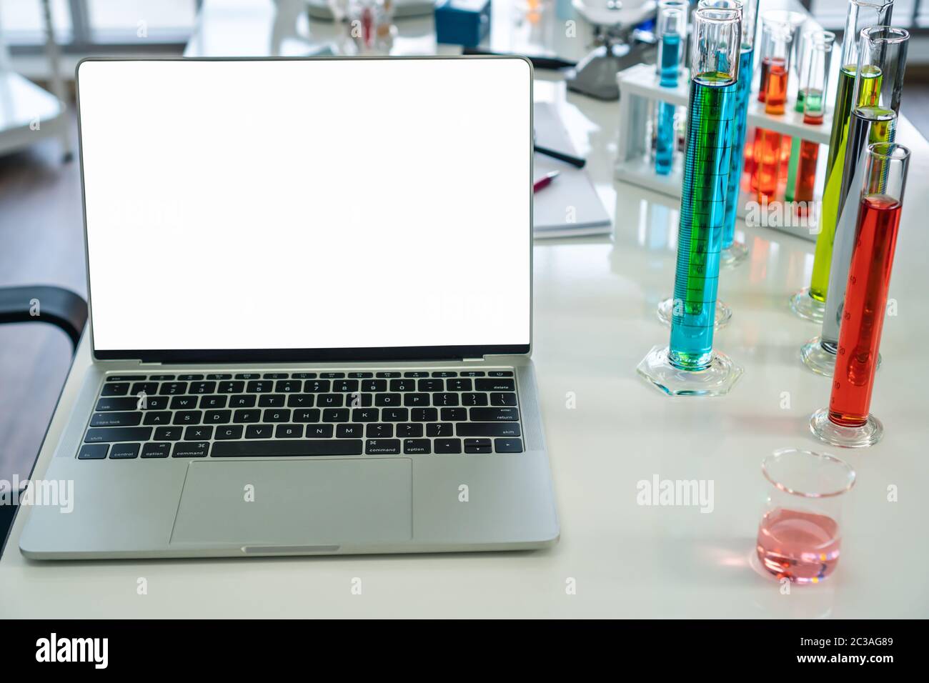 The white screen laptop is located on the scientist's desk. And there ...