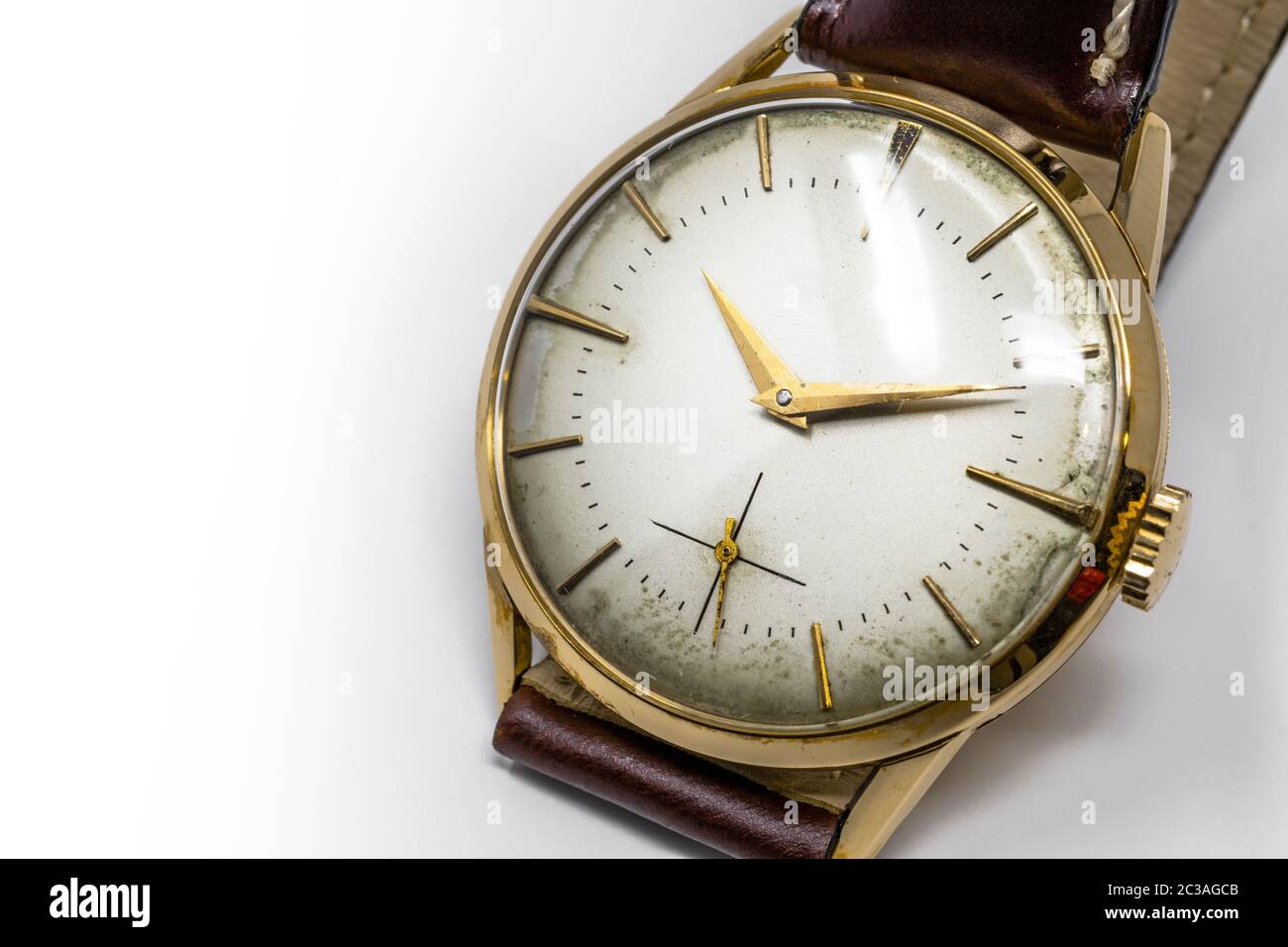 An old gold mechanical wristwatch with manual winding. Antique watch ...