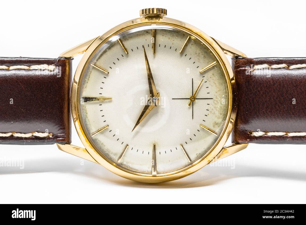 An old gold mechanical wristwatch with manual winding. Antique watch ...
