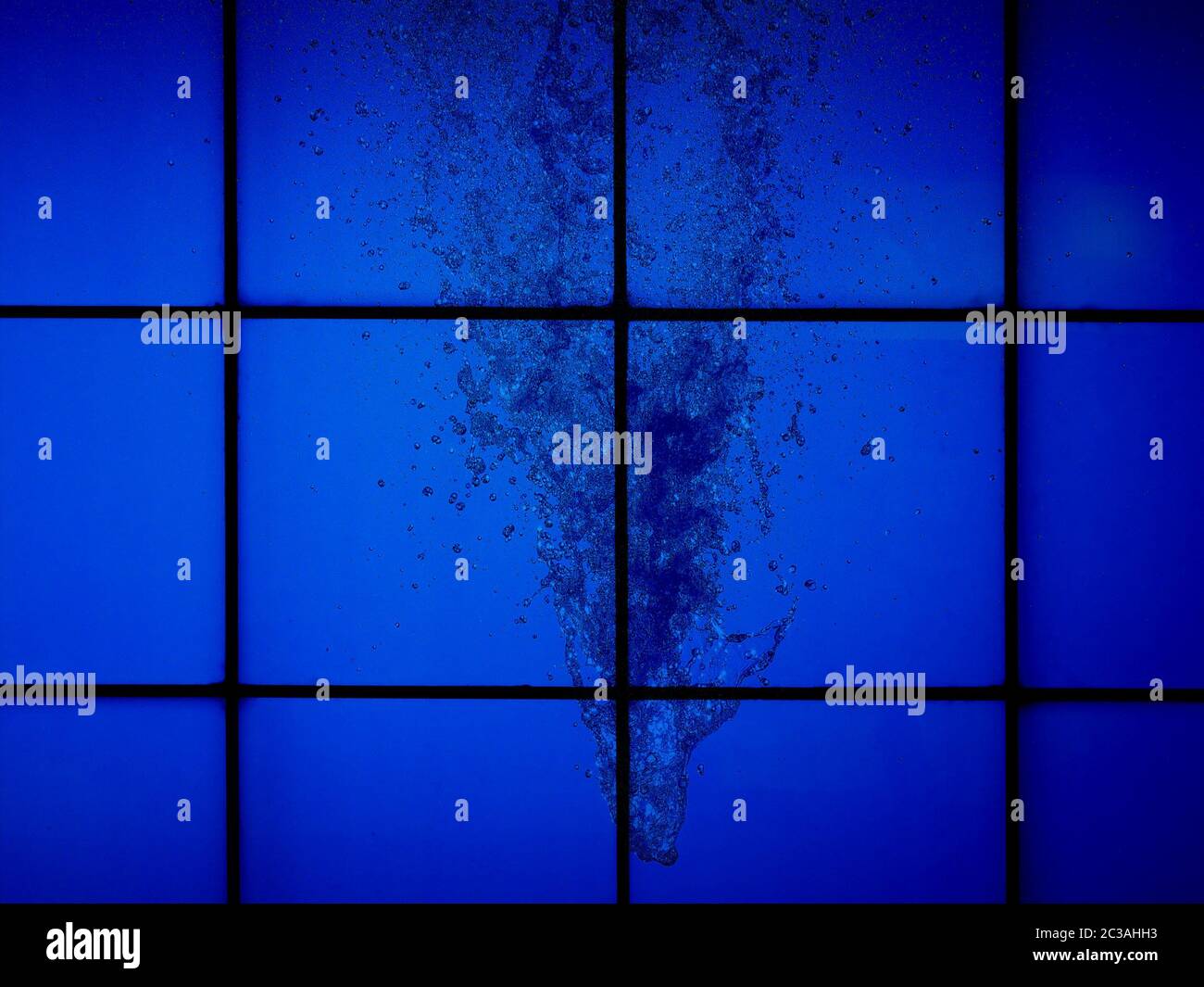 blue water flow splash behind glass wall useful as a background Stock ...