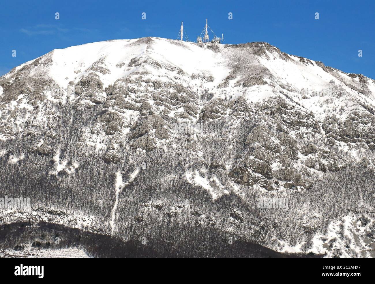 Tall mountain under snow with signal repetition towers on top Stock ...