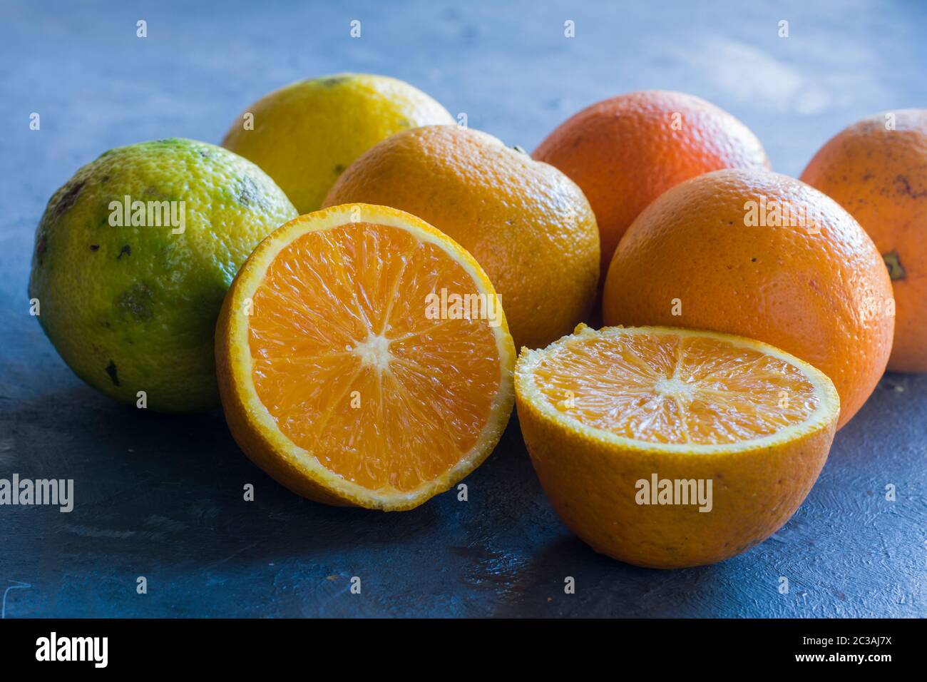 A group of oranges and lemons and one orange cut. Healthy fruit Stock ...
