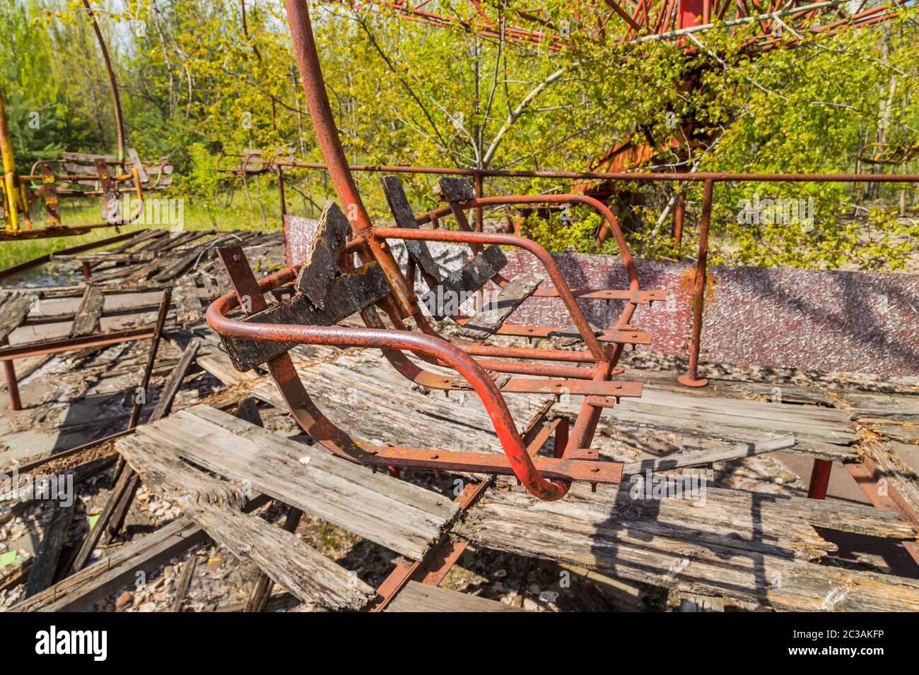Old broken rusty metal radioactive children's electric wheel abandoned ...